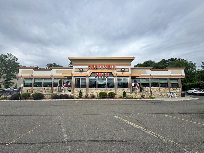 The gleaming red letters of Northvale Diner beckon like a lighthouse for the breakfast-starved. Classic architecture with modern touches promises comfort inside.