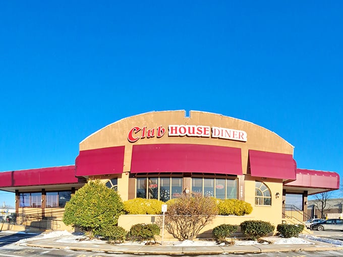 Winter sunshine bathes the Club House Diner's distinctive curved roofline and burgundy awnings—a beacon of comfort food hope on even the chilliest Pennsylvania days.