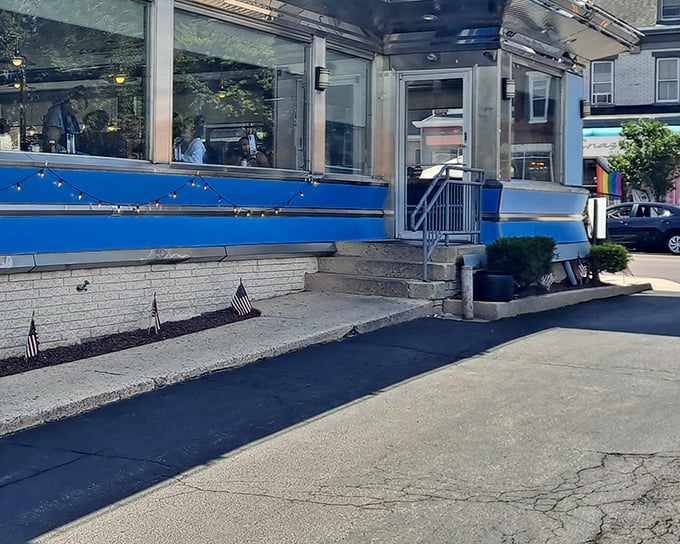 Small-town Americana at its finest—the blue trim and patriotic touches on this classic diner exterior invite you to step back in time for a meal worth remembering.
