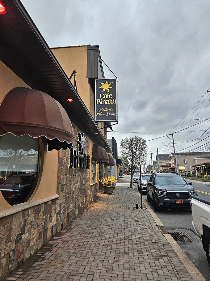 The classic stone façade and distinctive brown awnings of Café Rinaldi invite you into Old Forge's Italian treasure, promising authentic flavors behind those doors.
