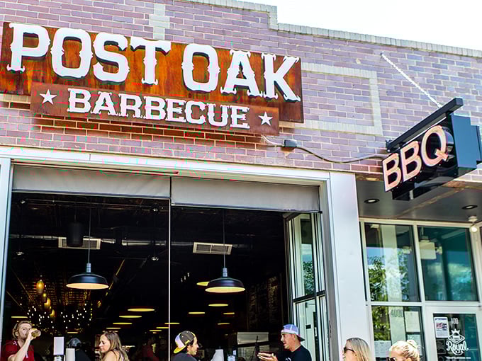 The rusted patina of Post Oak's sign isn't just for show—it's a promise of authentic Texas-style barbecue waiting inside.