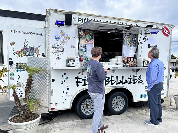 The unassuming white trailer with its cheerful turquoise canopy proves once again that culinary greatness rarely comes with a dress code.