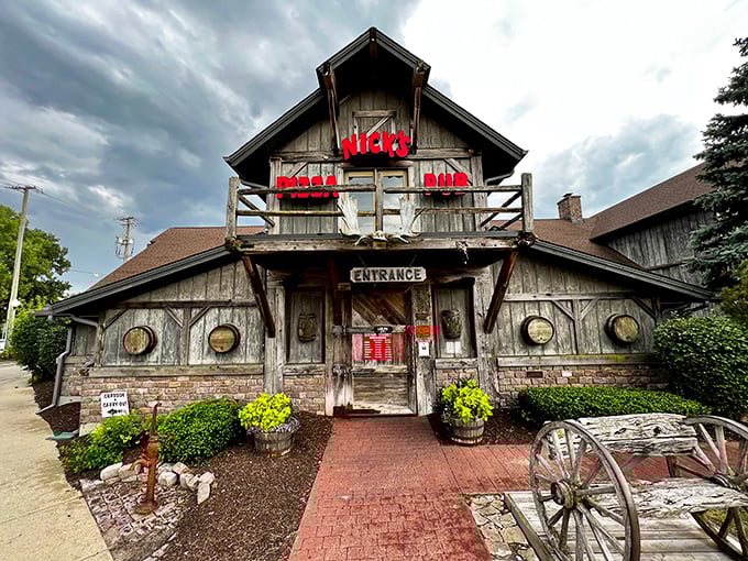 The rustic log cabin exterior of Nick's Pizza & Pub looks like Paul Bunyan's dream retirement home, complete with weathered wood charm and inviting front porch.