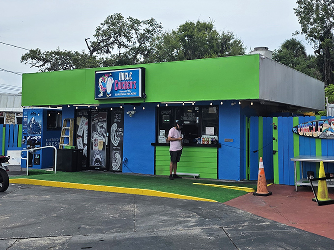 The surfing chicken beckons from this vibrant blue sign – a promise of coastal flavor that's about to change your fried chicken expectations forever.