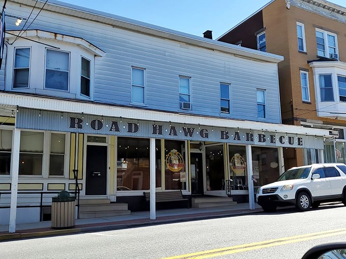 The unassuming white storefront with bold "ROAD HAWG BARBECUE" lettering promises smoky treasures within. Small-town charm, big-time flavor.
