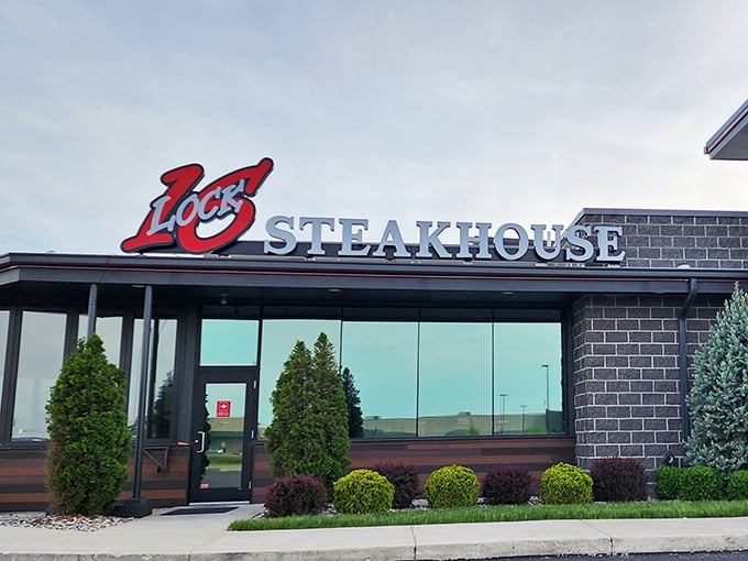 The bold red signage announces your arrival at steak paradise – no secret handshake required, just an appetite for excellence.