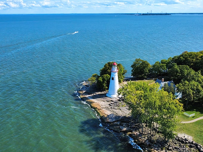 The quintessential Great Lakes postcard come to life—Marblehead's white sentinel stands guard where land meets water in perfect harmony.