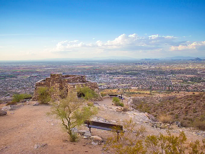 The stone ramada at Dobbins Lookout stands like a desert sentinel, offering shade and spectacular views that make Phoenix look like a miniature model city.