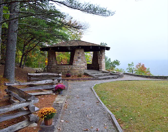 One of Kingdom Come's charming CCC-built stone shelters, where even foggy days feel magical. Those mums add a pop of color that says "autumn in Appalachia" better than words ever could.