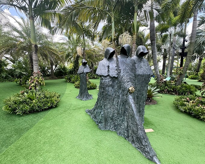 The mysterious hooded figures stand like silent sentinels among the palms, creating an atmosphere that's equal parts enchanting and delightfully eerie.