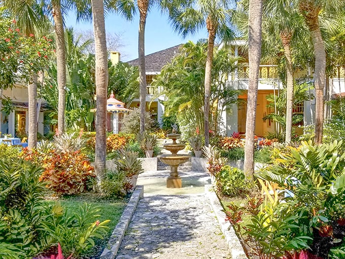 A stone pathway flanked by tropical splendor leads to the buttery-yellow main house—Florida's version of the yellow brick road to paradise.