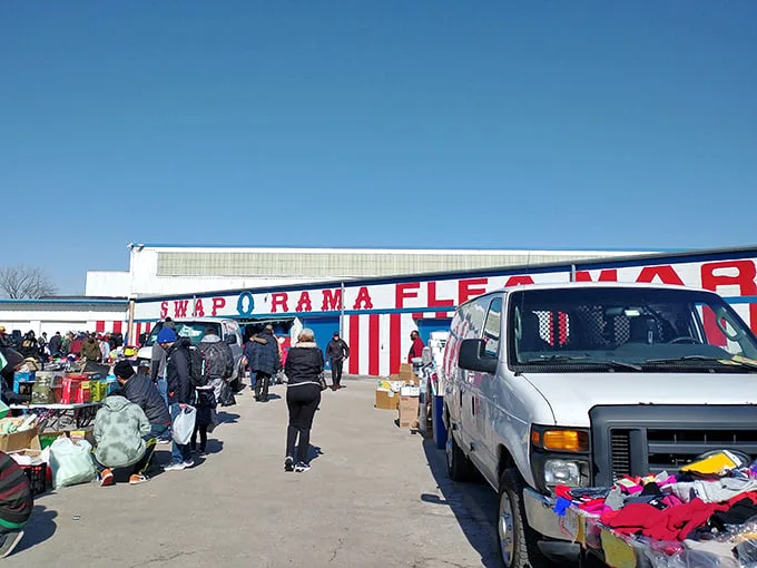 The red and white striped exterior of Swap-O-Rama beckons like a circus of commerce under clear Illinois skies. Treasure hunting begins here!