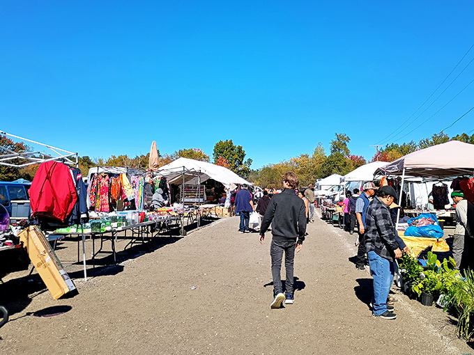 The treasure hunter's highway! Rows of vendor tents create a marketplace boulevard where weekend warriors search for deals under New Hampshire's brilliant blue skies.