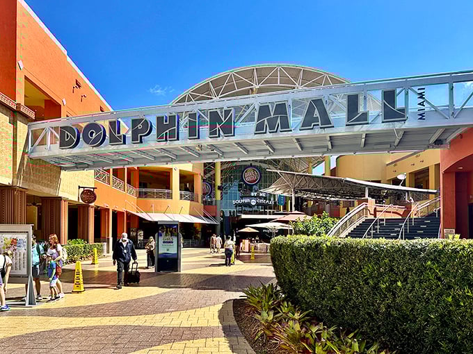 The grand entrance to Dolphin Mall welcomes shoppers with its distinctive architecture and warm Miami colors—retail therapy's pearly gates.