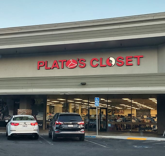 The bright red Plato's Closet sign beckons like a fashion lighthouse, promising treasure within those unassuming walls. Style salvation awaits!