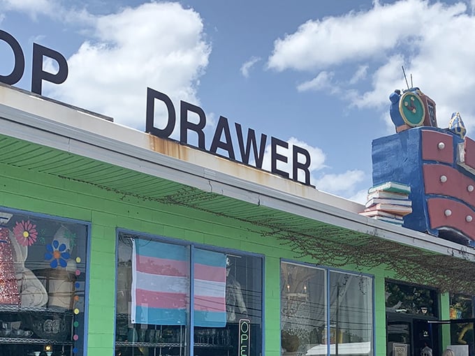 The lime green exterior of Top Drawer Thrift isn't just eye-catching—it's practically shouting "treasures inside!" with its whimsical rooftop dresser display.