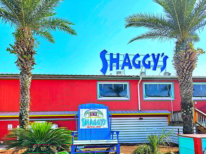 Shaggy's vibrant red exterior with towering palm trees isn't just a restaurant—it's a beacon of seafood salvation on Biloxi Beach.