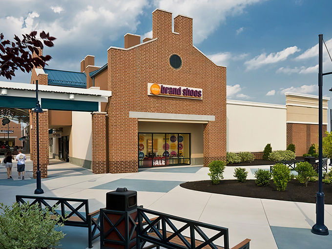 The brick façade of Brand Shoes welcomes bargain hunters like an architectural wink that says, "Yes, your credit card will survive this encounter."