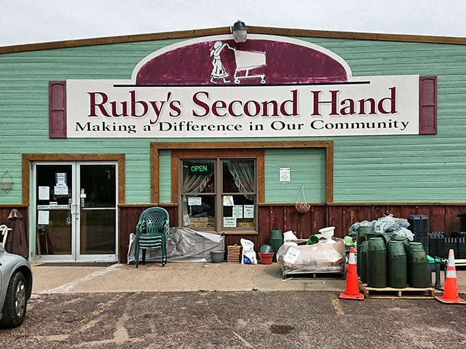The mint-green exterior of Ruby’s Second Hand catches the eye, its bold burgundy sign inviting thrifters to uncover hidden gems inside.