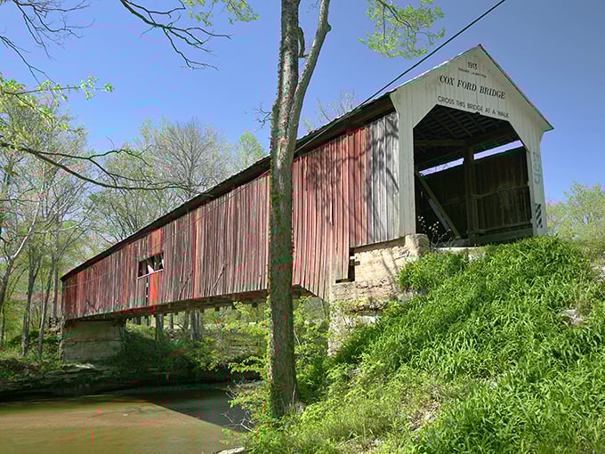 The bridge's weathered red siding and white entrance create a classic Americana postcard moment. Just add a vintage car and you've got yourself a calendar shot.