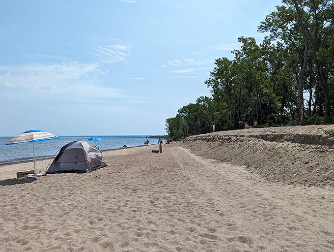 Beach camping at its finest – because sometimes paradise needs a tent and a colorful umbrella for company.