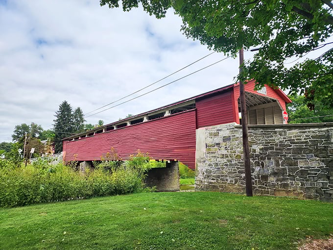 The Wehr Covered Bridge stands proudly against a blue Pennsylvania sky, its classic red siding practically begging to star in your next holiday card.