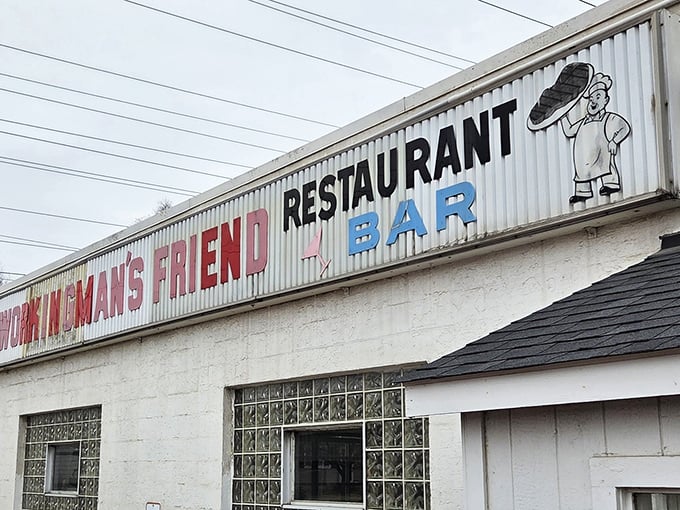The corrugated metal sign says it all – unpretentious, straightforward, and promising exactly what you'll find inside: good food and cold drinks.