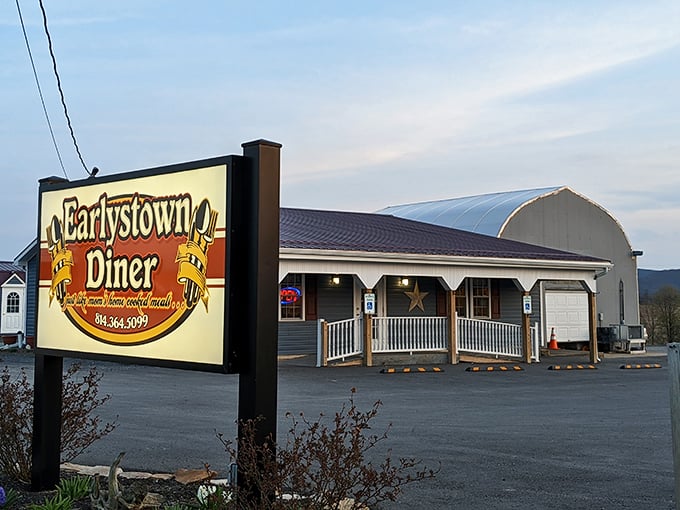 A different angle reveals the diner's charming front porch and illuminated sign—like finding the Emerald City of breakfast at the end of a country road.