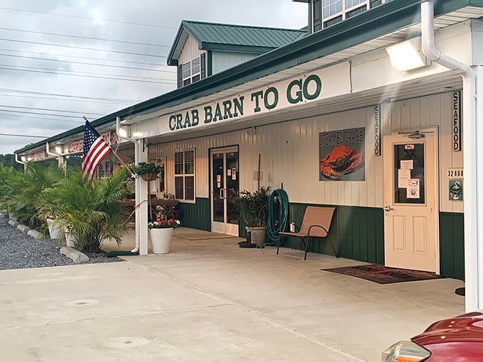 The classic white-and-green exterior of Crab Barn beckons seafood lovers like a lighthouse guides ships—toward delicious waters.