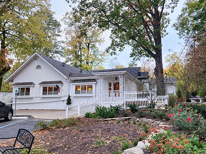 he charming white cottage exterior of Hollyhock Hill stands like a time capsule among the trees, promising comfort food that transcends generations.