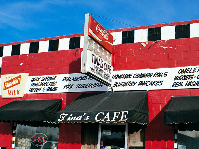 The red building with its checkered racing flag trim isn't just eye-catching—it's a roadside beacon promising comfort food that'll make your taste buds do victory laps.