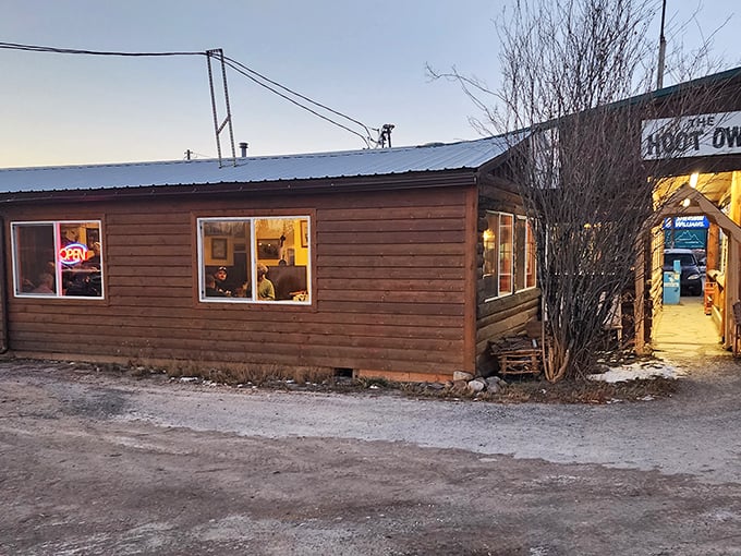 The unassuming wooden exterior of Hoot Owl Café glows with promise at dusk, like a beacon calling hungry travelers home.