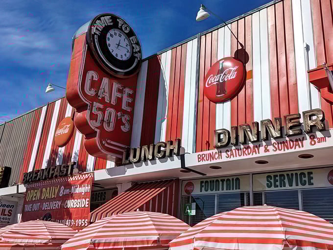 The candy-striped awnings and vintage clock sign aren't trying to be retro – they're the real deal, a time portal disguised as a diner on Santa Monica Boulevard.