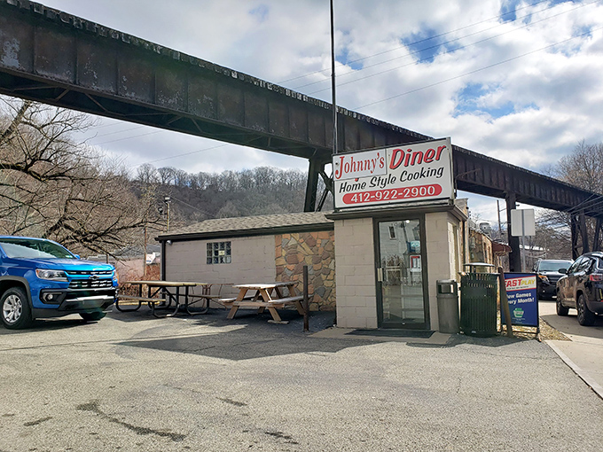 Nestled under a railroad trestle, Johnny's Diner looks like it was built on a dare—and has been winning that bet for decades.