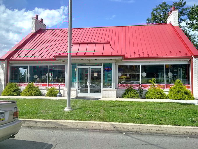 Its white brick exterior, bright red roof and trim, and welcoming entrance stand out as a beacon for hungry travelers.