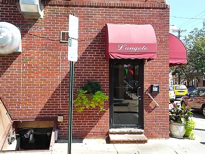 The unassuming brick exterior with its modest red awning is the culinary equivalent of Clark Kent's glasses – hiding superhero-level Italian cuisine inside.