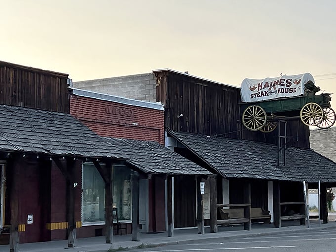 The iconic wagon sign perched atop Haines Steak House isn't just decoration—it's a beacon calling hungry travelers from miles around to this rustic wooden treasure.