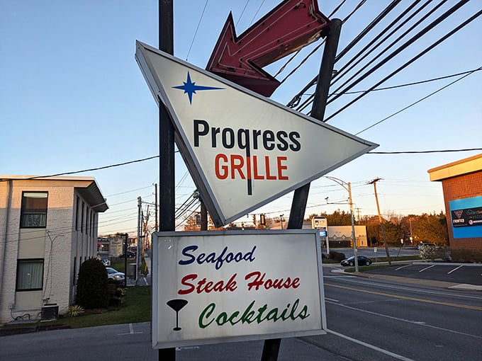 By day, the retro sign stands as a beacon of hope for hungry travelers; by night, it transforms into a glowing promise of carnivorous delights ahead.