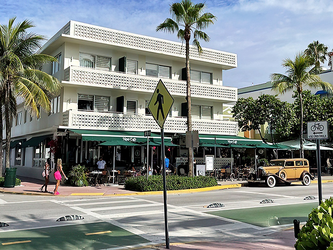 The iconic white Art Deco facade of News Cafe stands proudly on Ocean Drive, where Miami Beach's past and present mingle over coffee and conversation.