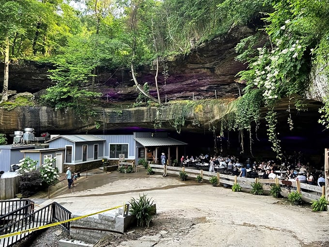 The ultimate "dinner with a view" doesn't involve skyscrapers or ocean vistas—it's this magnificent rock overhang sheltering hungry patrons from both sun and conventional restaurant expectations.