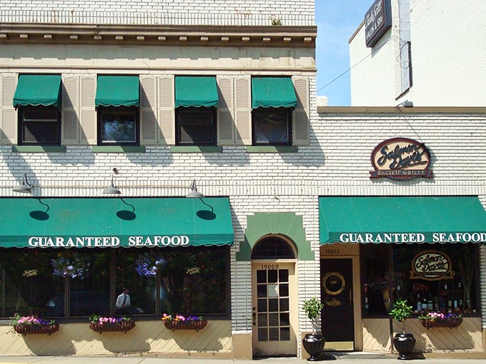 The promise of "Guaranteed Seafood" isn't just a slogan – it's a commitment carved into those classic green awnings and white brick facade.