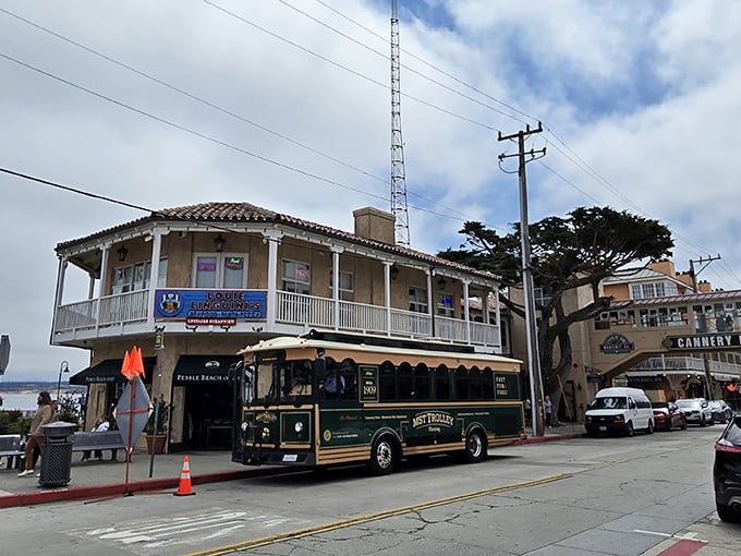 The historic trolley passing by Louie Linguini's feels like a time machine to Monterey's cannery days—except with better food options now.