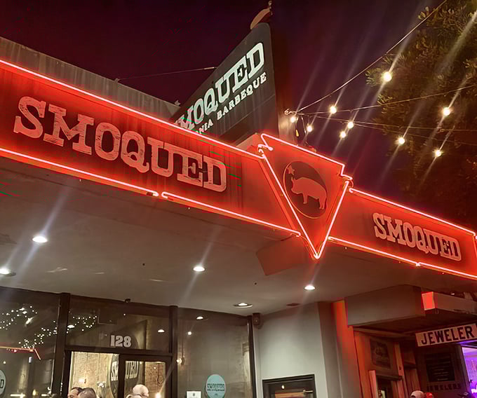 The neon glow of Smoqued's sign beckons like a barbecue lighthouse, guiding hungry souls through the night to smoky salvation.