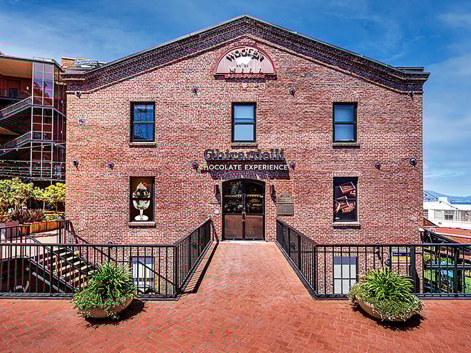 The historic brick facade of Ghirardelli's Woolen Building stands like a chocolate cathedral, promising sweet salvation within those hallowed walls.