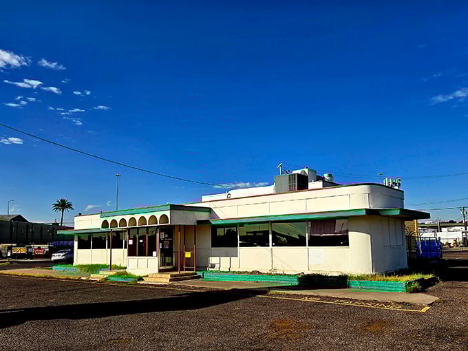Standing proudly against the Arizona sky, Mel's Diner's white-and-mint exterior is like a time machine disguised as a building.