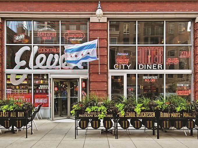 The Chicago flag waves proudly alongside neon promises of delicatessen delights – a beacon for hungry souls in the South Loop.