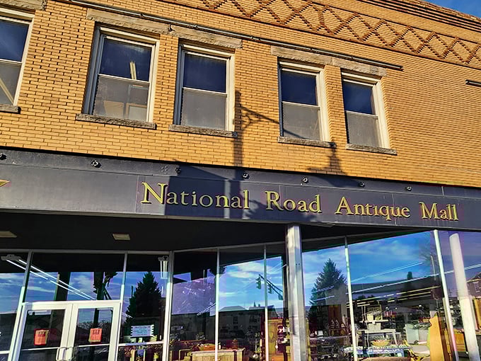 The iconic yellow brick façade of National Road Antique Mall stands proudly on Cambridge City's main street, a beacon for treasure hunters.