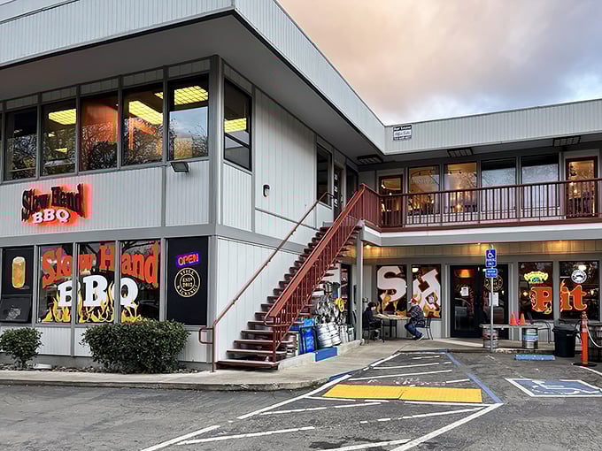 The unassuming exterior of Slow Hand BBQ beckons with its bright red staircase – like a secret clubhouse where the password is "hungry."