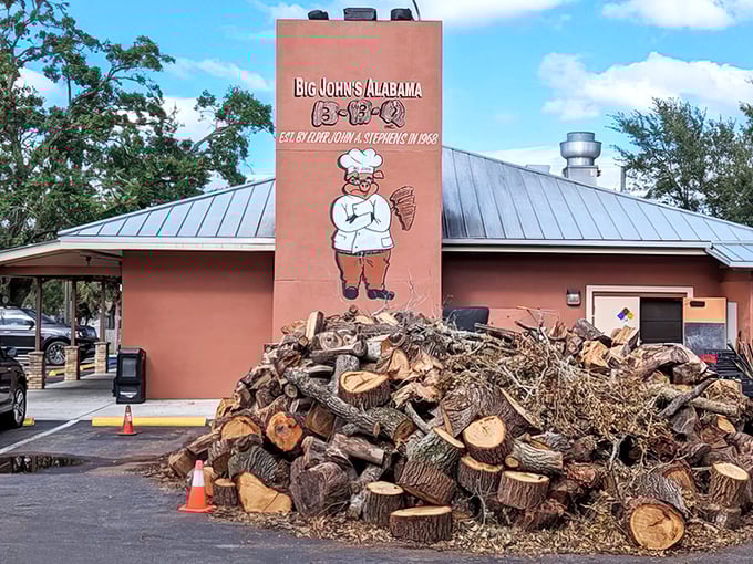 That mountain of wood isn't for show—it's the secret ingredient that transforms ordinary meat into smoky magic at this Tampa landmark.