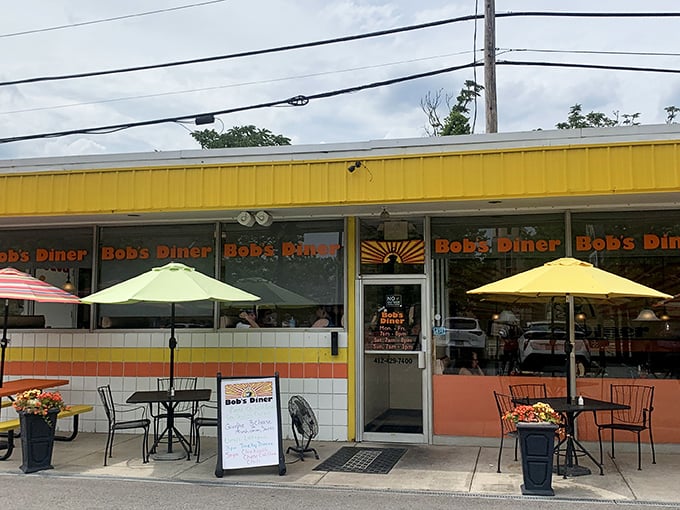 The sunshine-yellow exterior of Bob's Diner isn't just a color choice—it's a beacon calling hungry travelers home to Carnegie's beloved breakfast institution. 